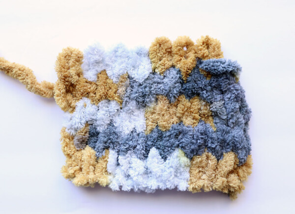 Make a gorgeous cable knit blanket with looping yarn (it's so easy ...